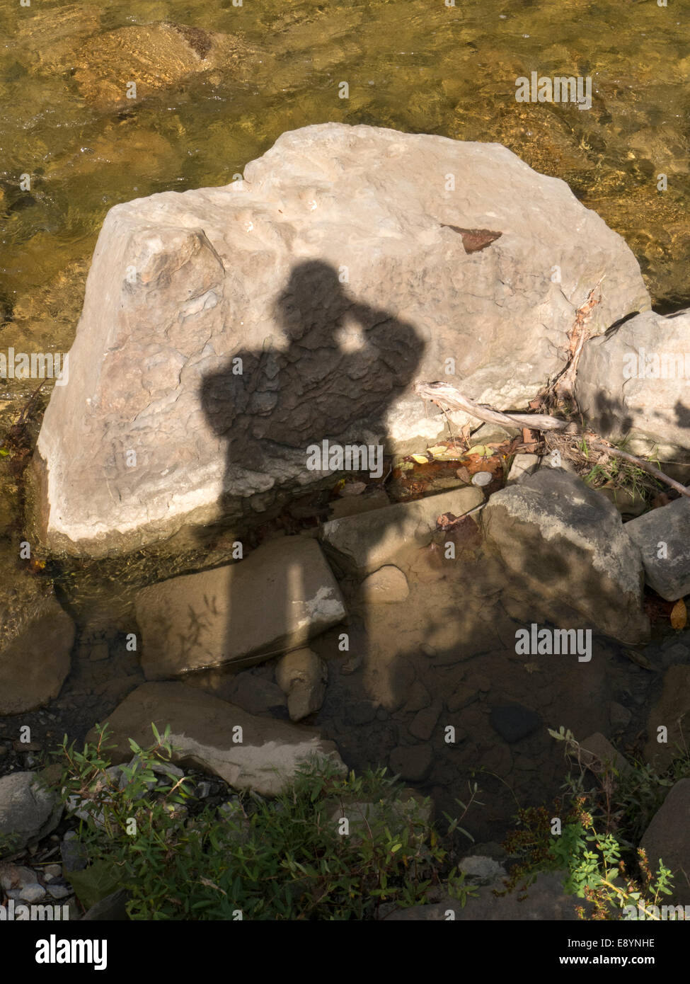 Photographers shadow on boulder Stock Photo - Alamy