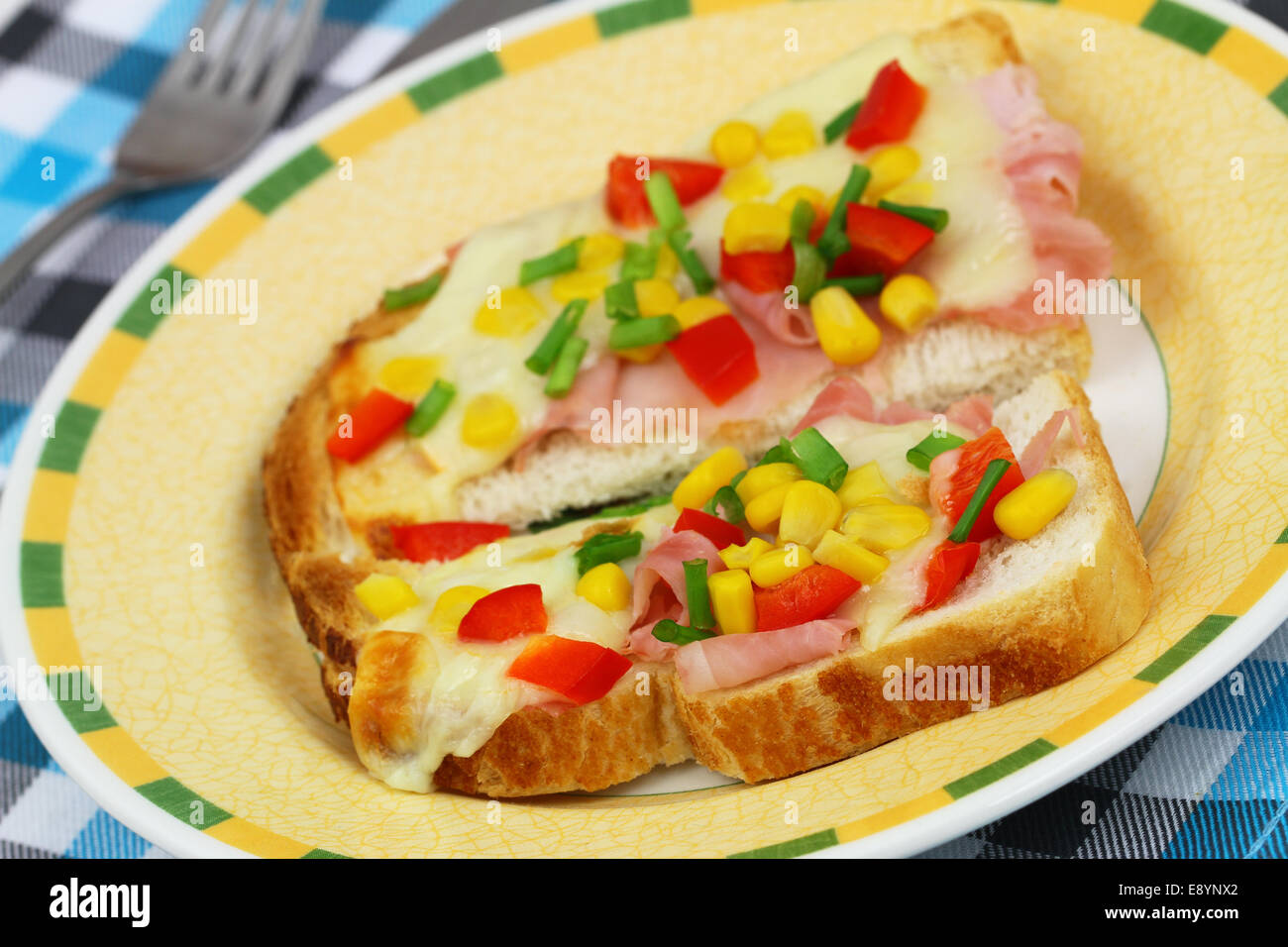 Toast with mozzarella, ham, red pepper and sweetcorn Stock Photo - Alamy