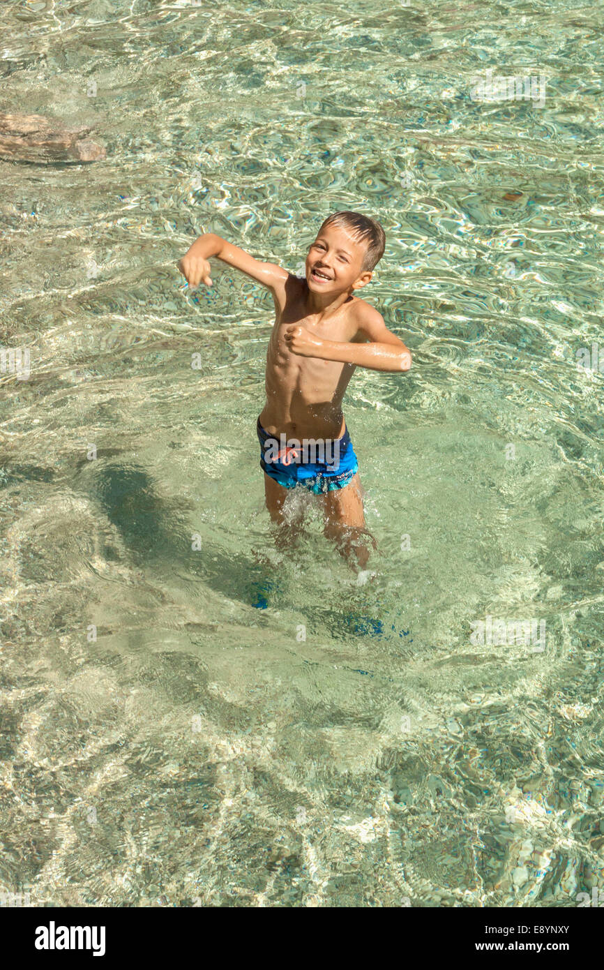 Boy jumping out of water in Lucisca bay near Sveta Nedilja village ...