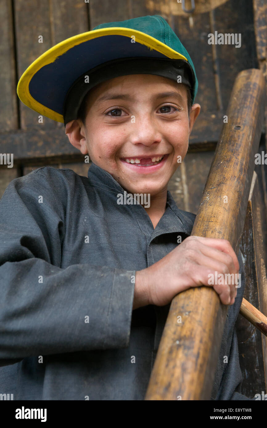 Smiling Kalash boy on the steps of a house at Krakl Village, Bumburet ...