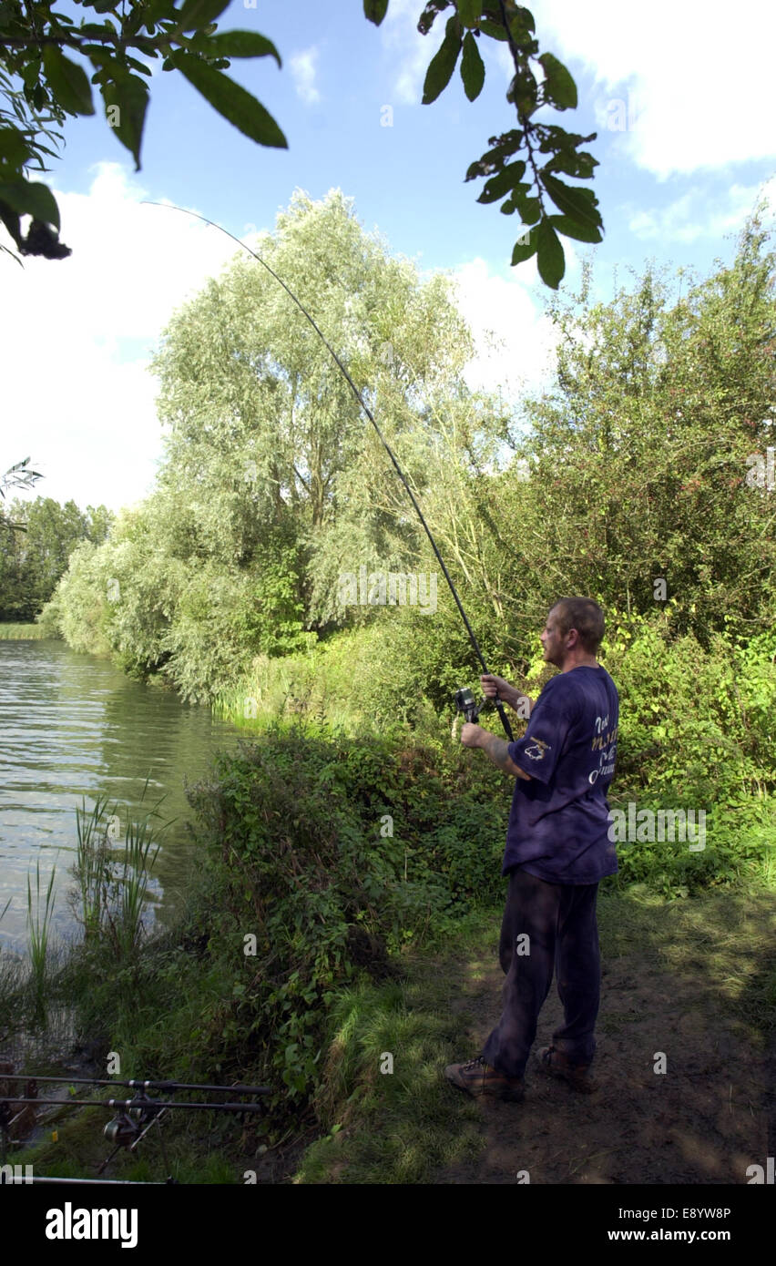 Man carp fishing on lake in Gloucestershire England UK Stock Photo - Alamy