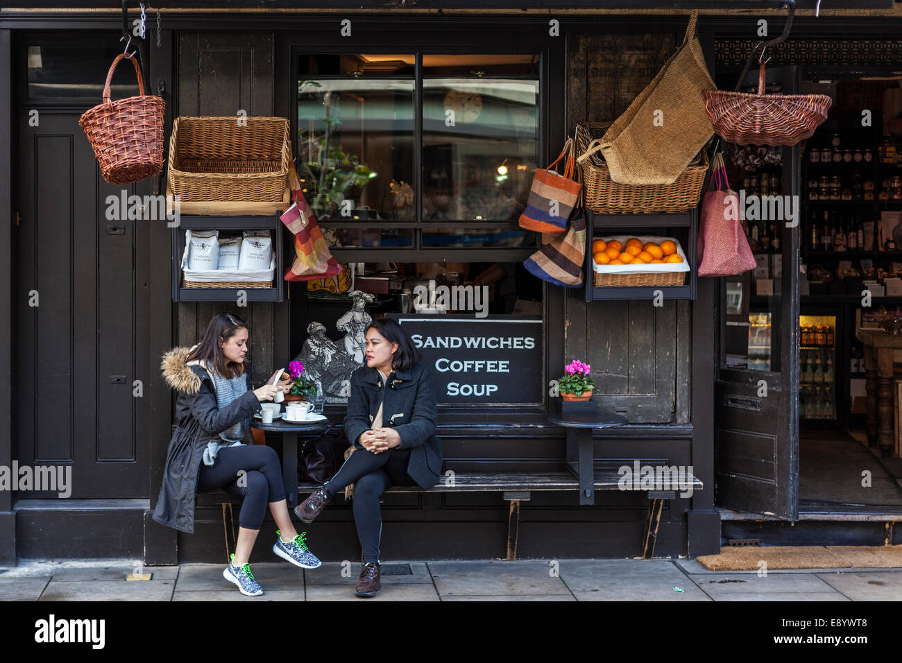 Two Ladies Taking Refreshments on Pavement Outside Cafe Stock Photo - Alamy