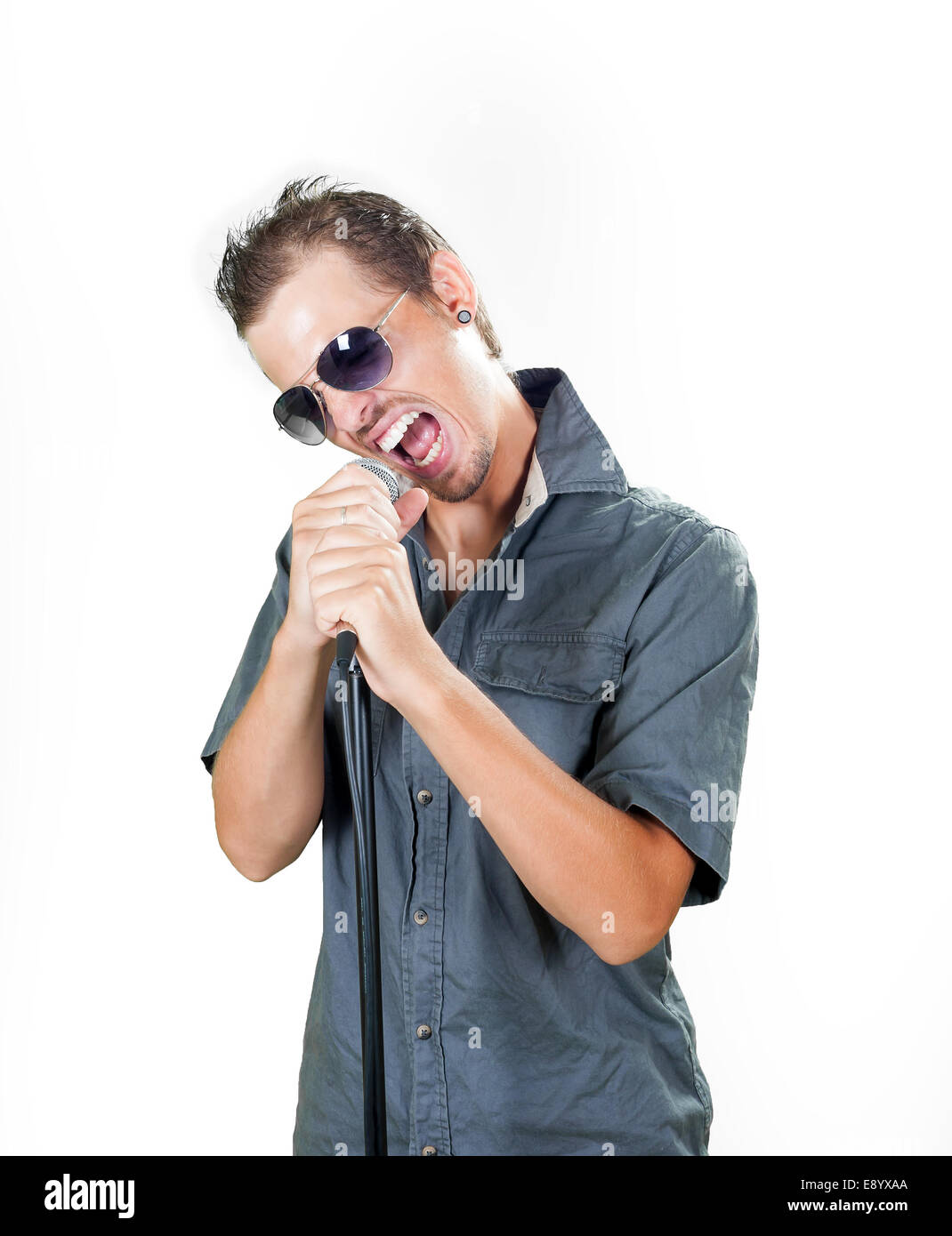 Young caucasian rock singer on the white background Stock Photo - Alamy