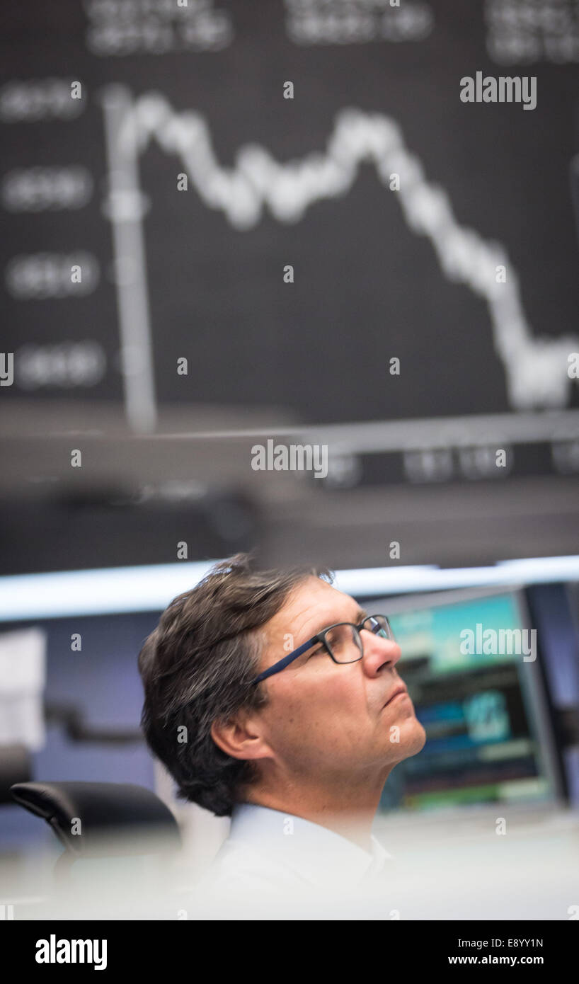 A stock trader sits in front of the DAX board on the trading floor of ...