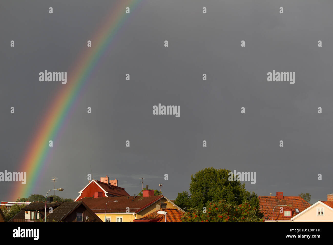 Rainbow over a city in Sweden Stock Photo - Alamy
