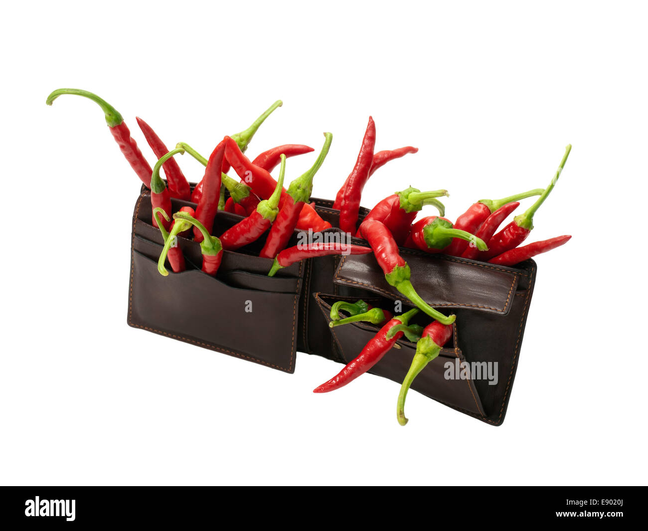 Conceptual image of a wallet full of chili peppers on a white ...