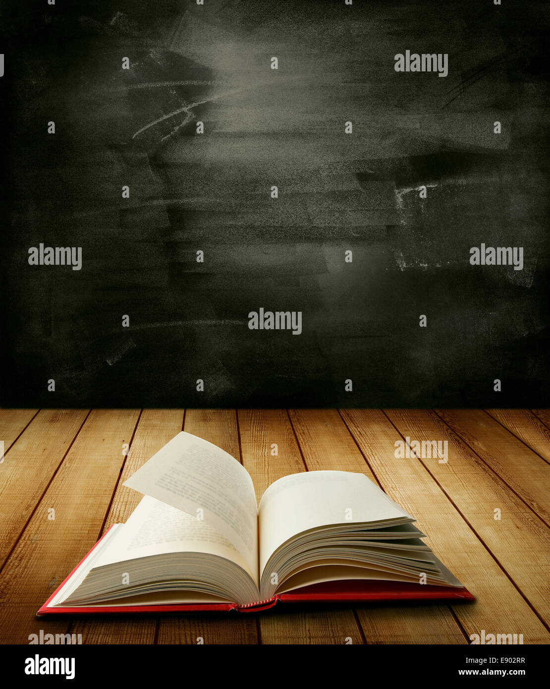 Open book in front of blackboard Stock Photo - Alamy