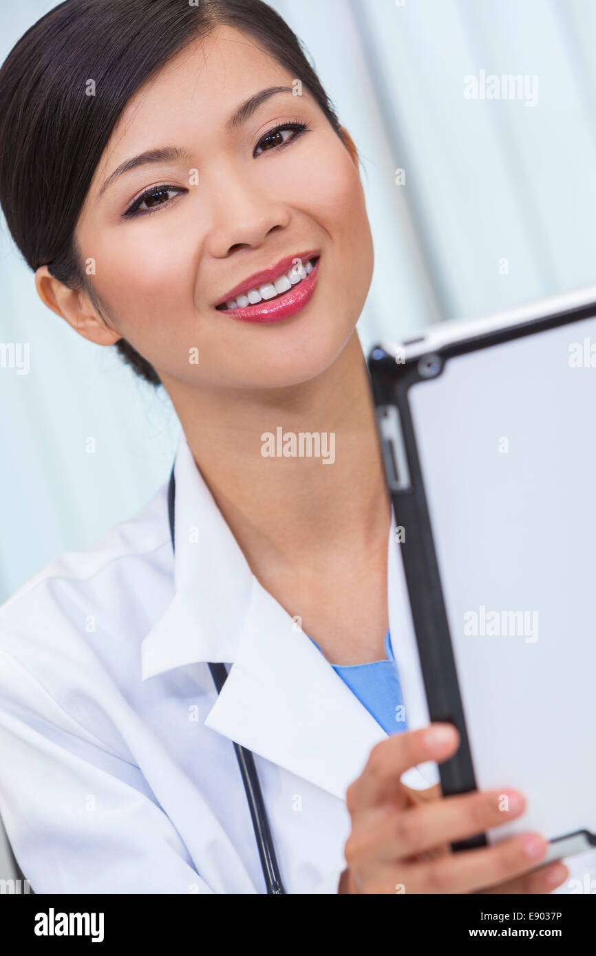 A Chinese Asian female medical doctor using a tablet computer in her ...