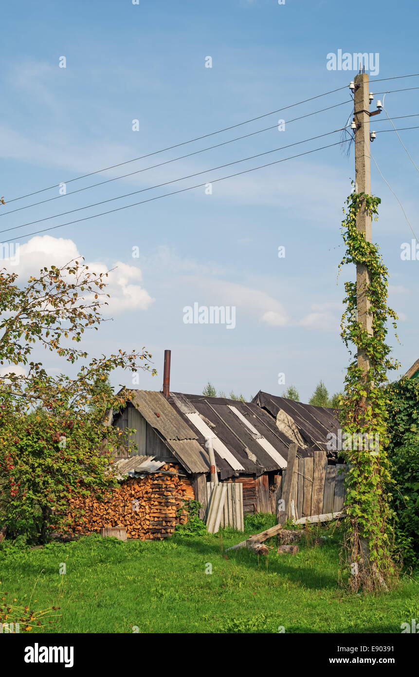 Village garden, barn, firewoods and electric wire column Stock Photo ...