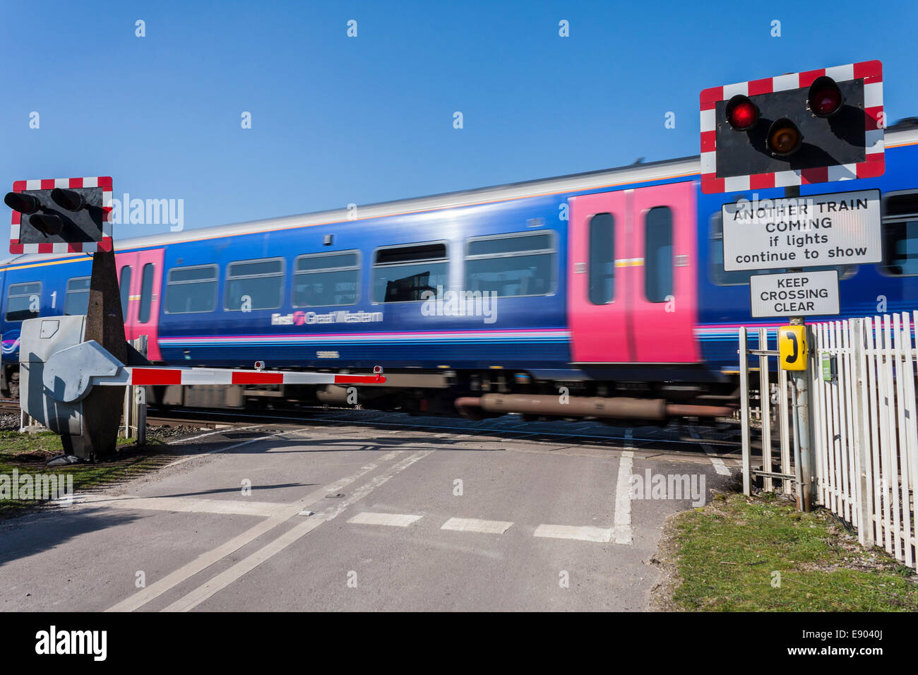 A First Great Western passenger train passes the level crossing at ...