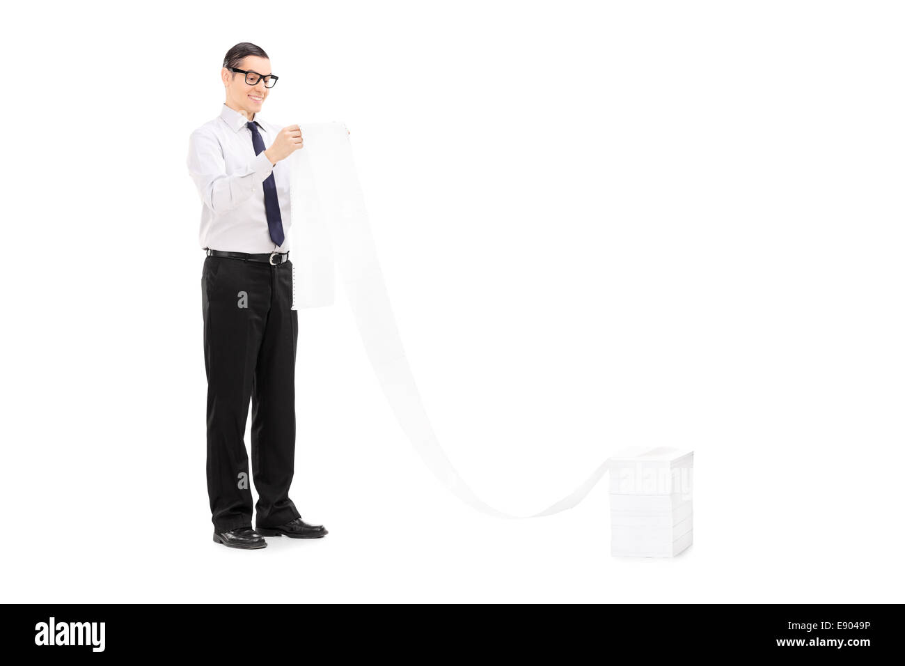 Joyful man looking at a very long list isolated on white background ...