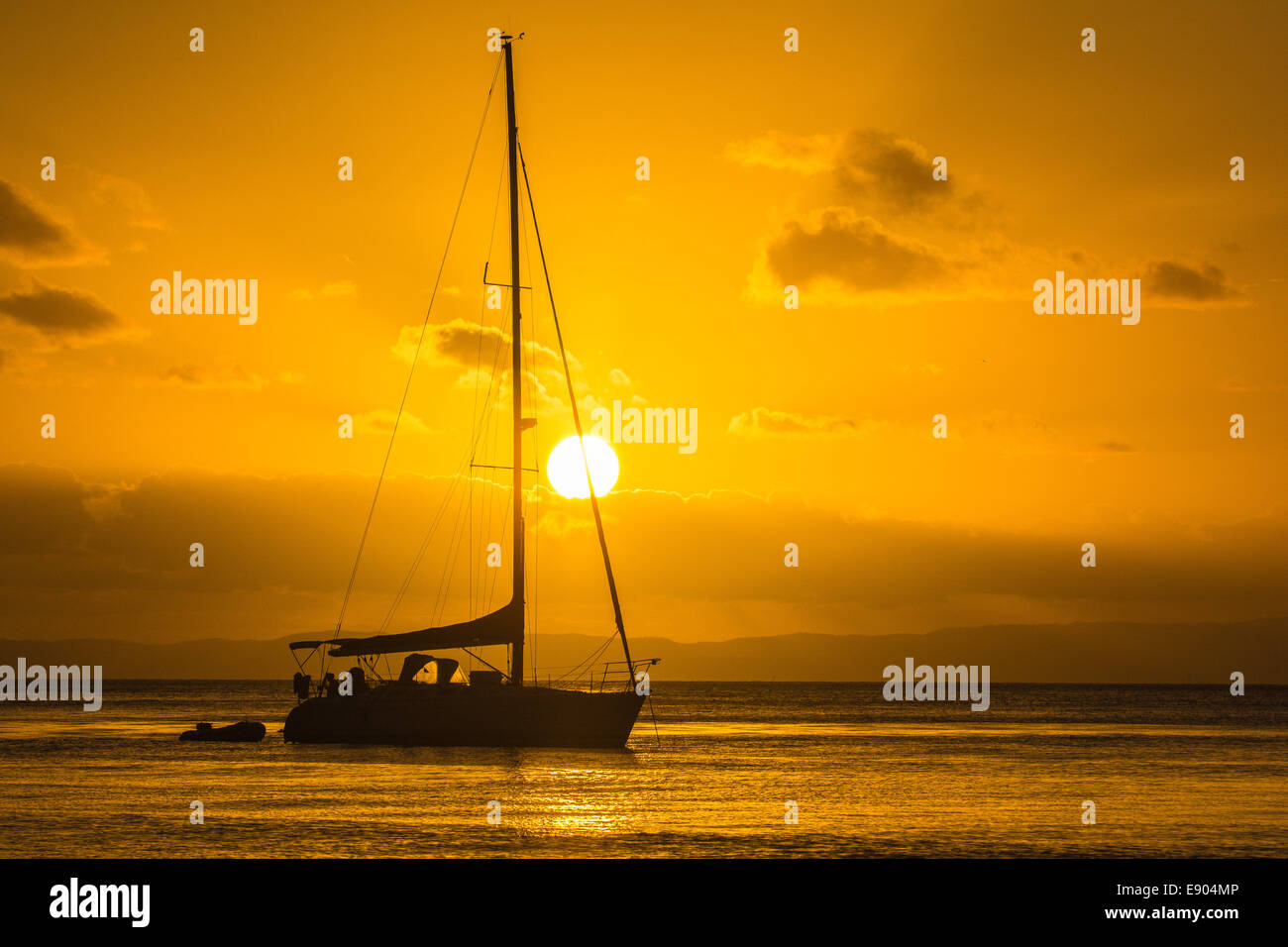 Boat anchored at sunset off of Tangalooma, Moreton Island, Queensland ...