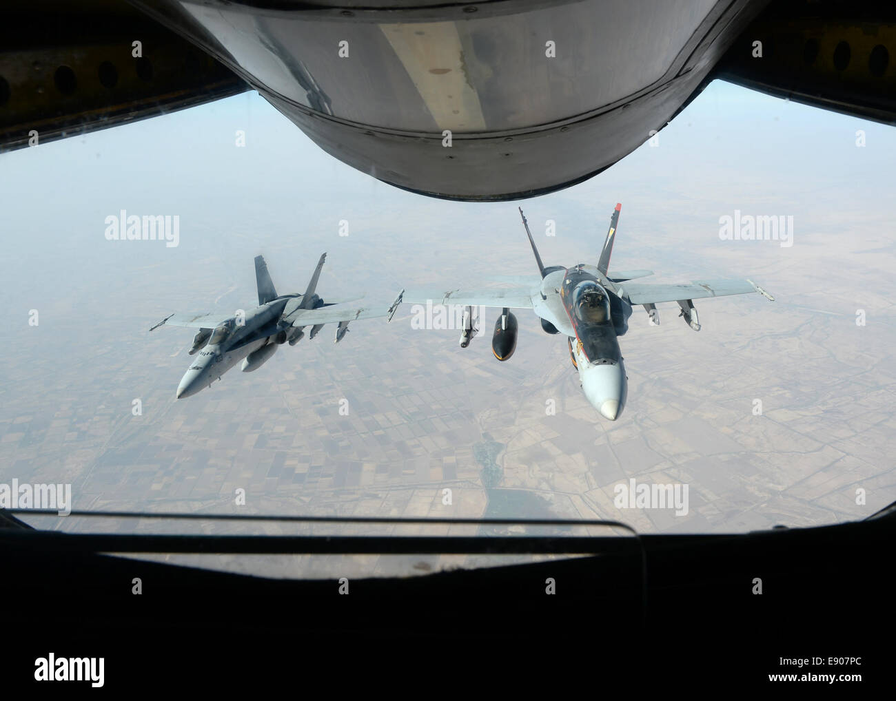 Two U.S. Navy F/A-18E Super Hornet aircraft fly after receiving fuel ...