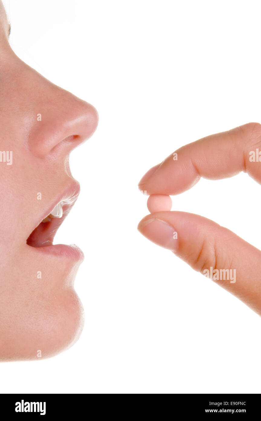 Woman taking pills Stock Photo - Alamy