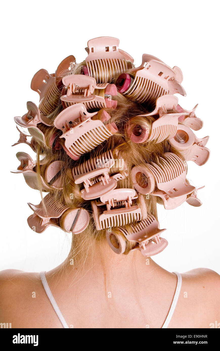 Young beautiful girl is having hair curlers on her head Stock Photo - Alamy