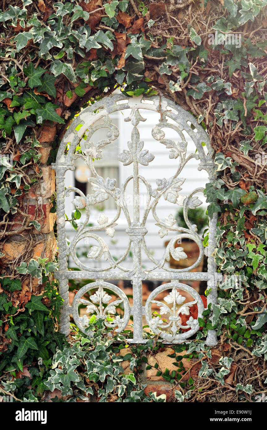 Ornamented ancient window in garden fence Stock Photo - Alamy