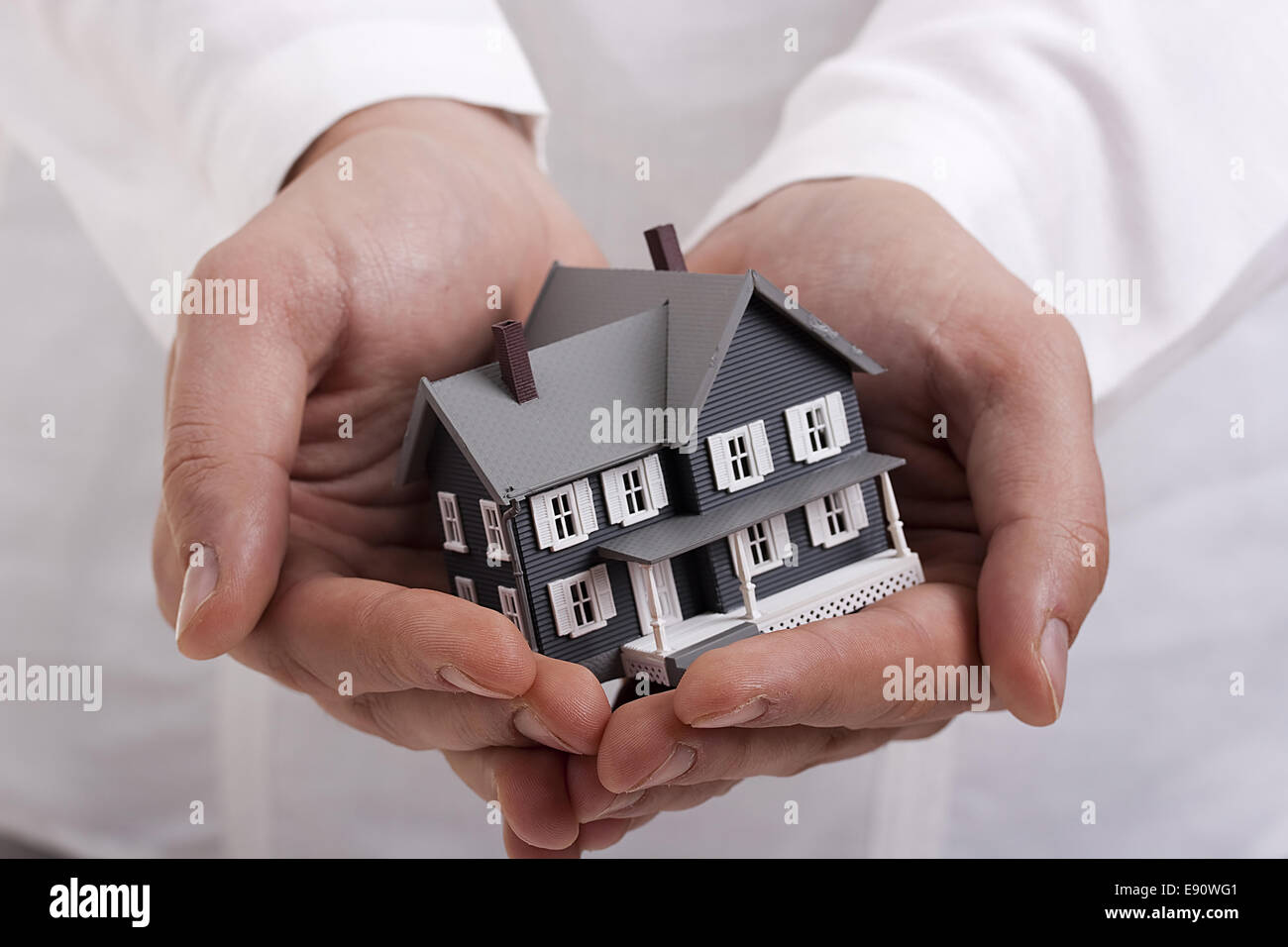 House in Hands Stock Photo - Alamy