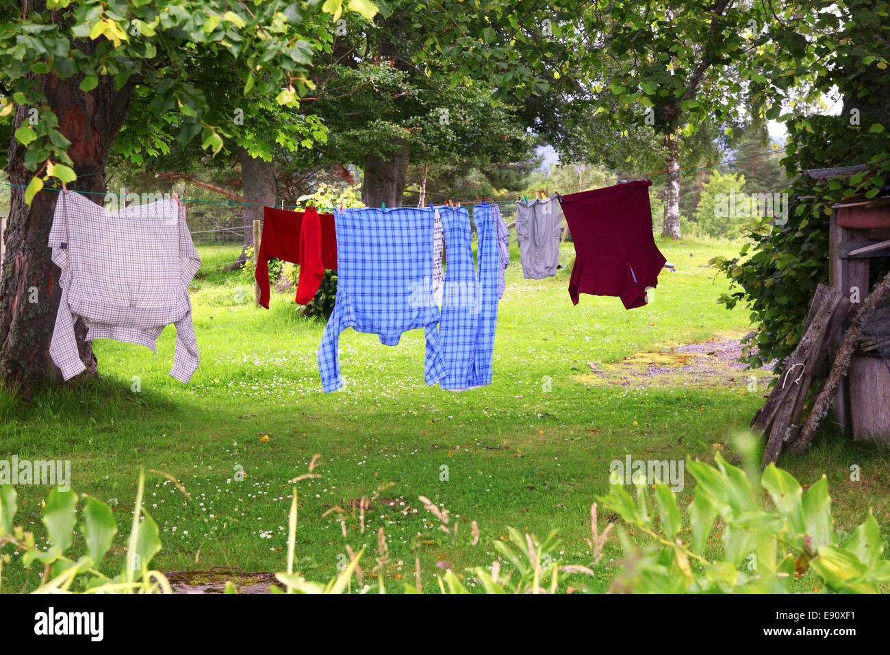 Different kind of clothing drying on a line Stock Photo - Alamy