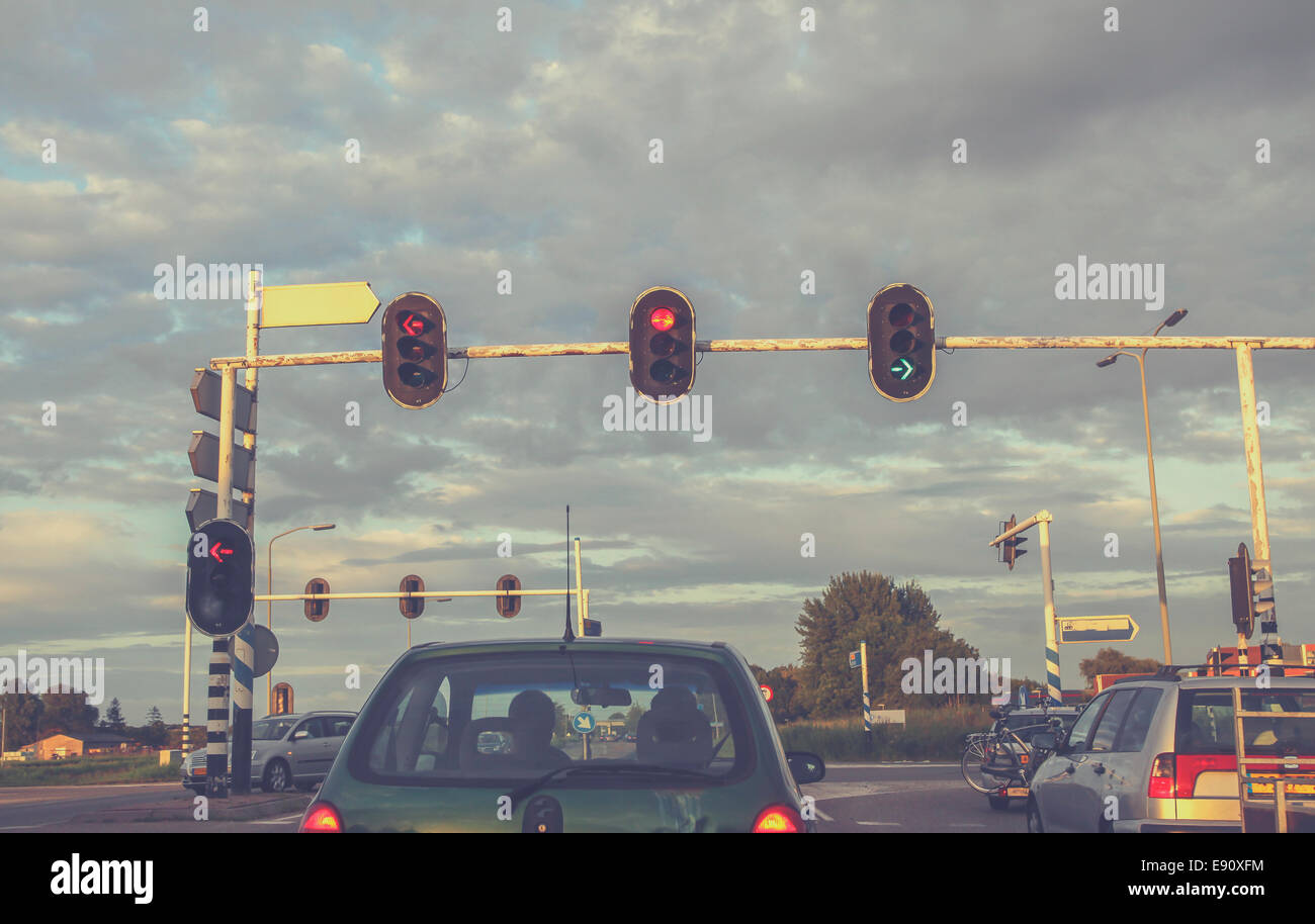 Cars waiting in front of traffic lights at sunset Stock Photo - Alamy