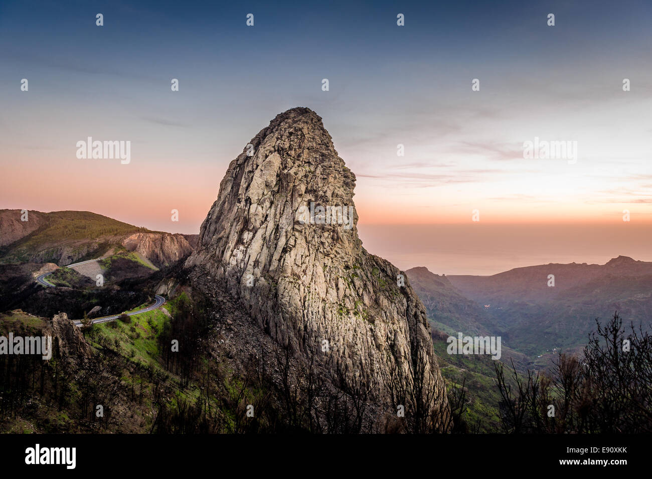 High rock at sunset Stock Photo - Alamy