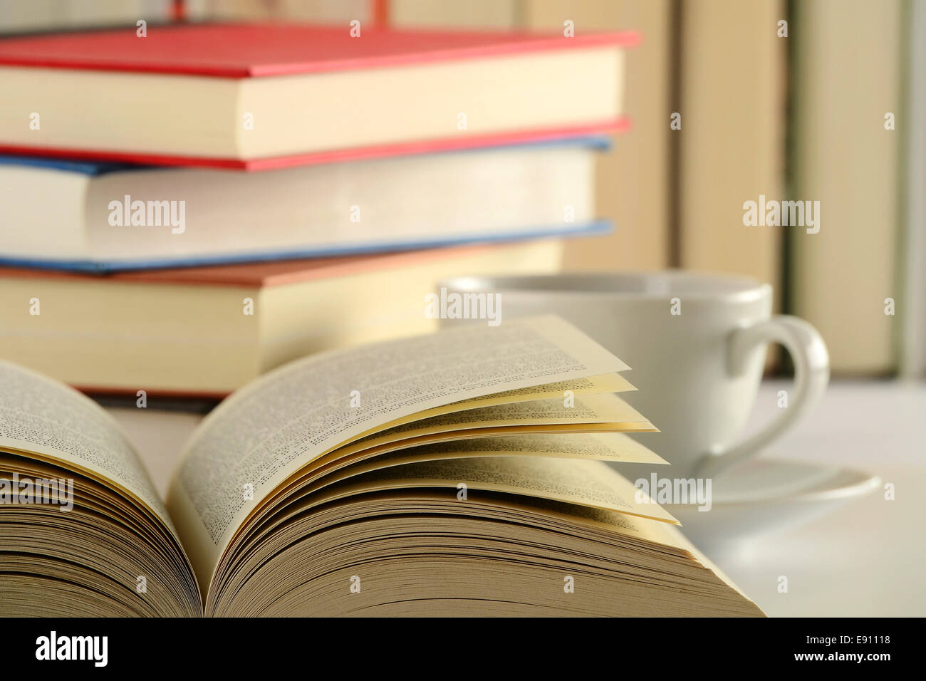 Open book and cup of coffee on the table Stock Photo - Alamy