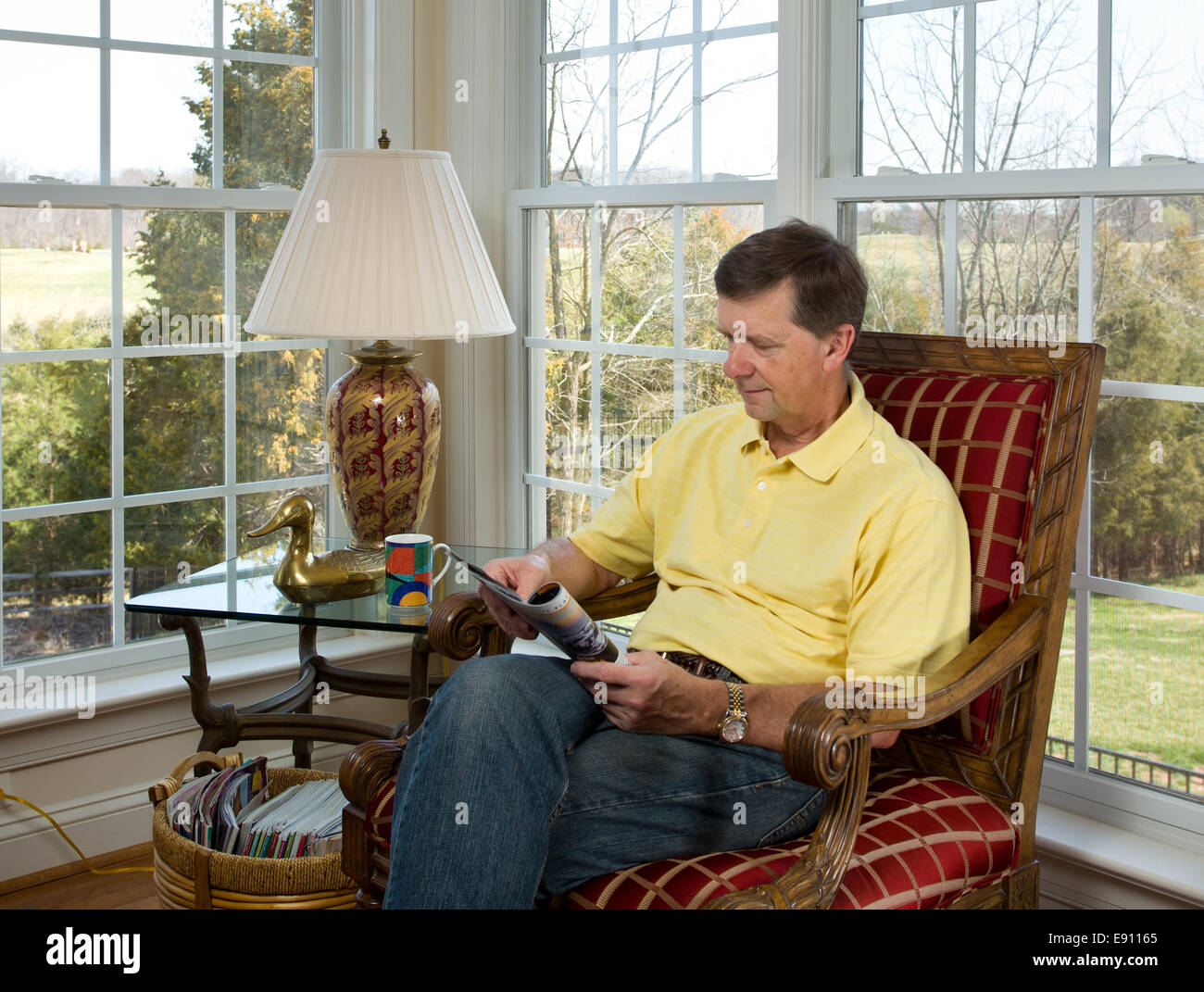 Boomer reading a magazine by garden Stock Photo - Alamy