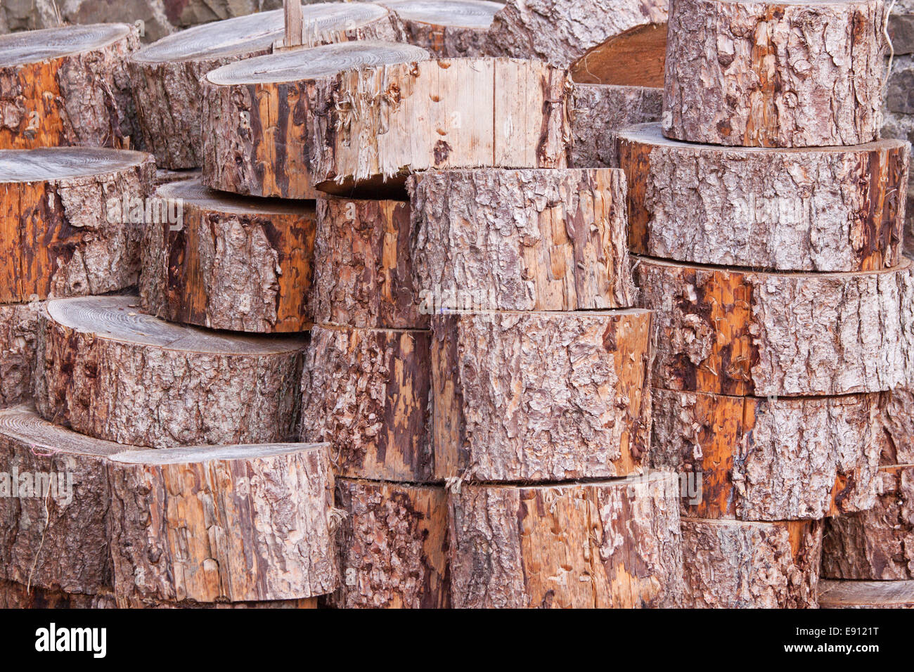 Chopped logs to be used for burning stacked in a lumber yard for drying ...