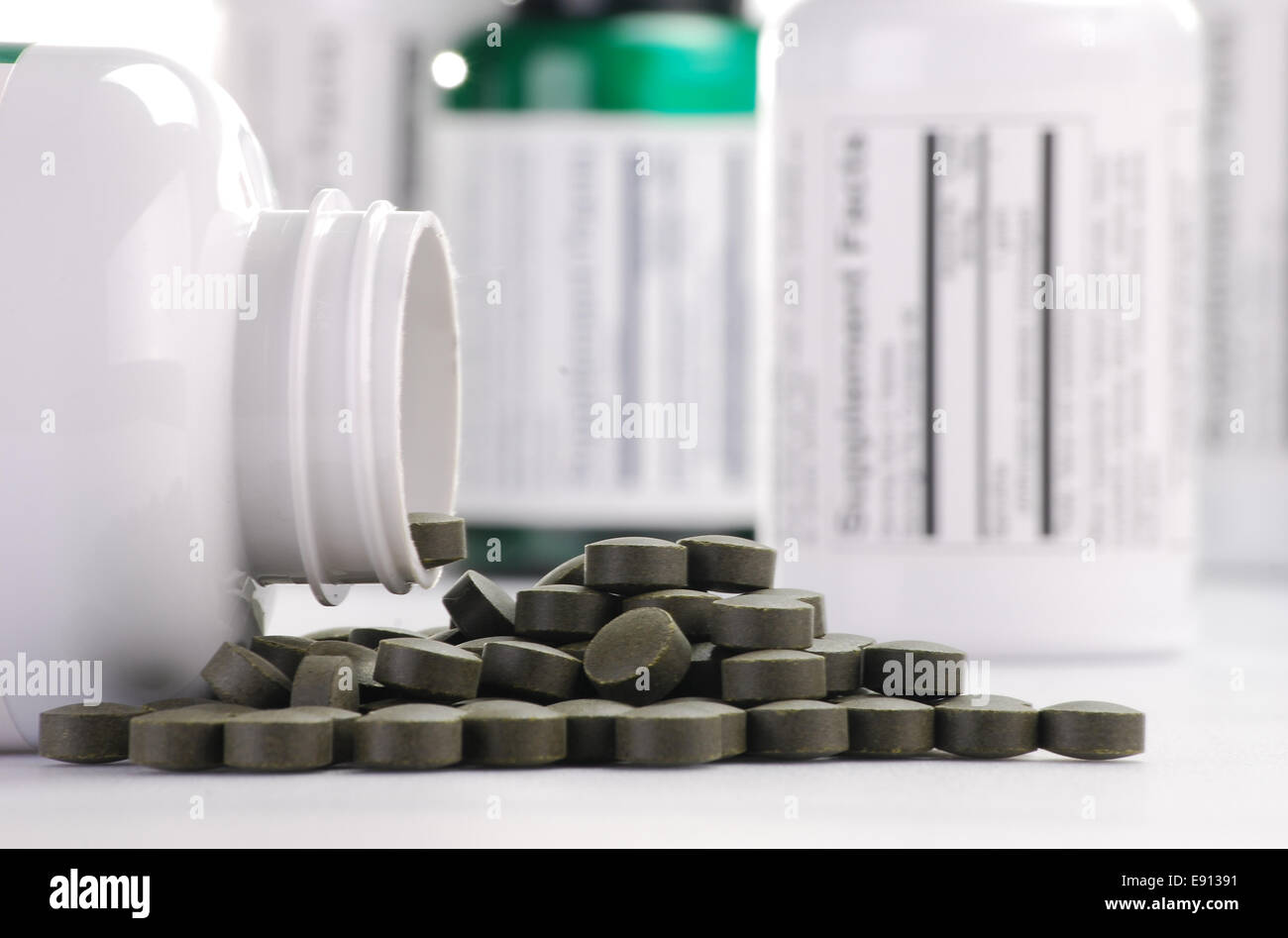 Dietary supplement tablets and containers Stock Photo - Alamy