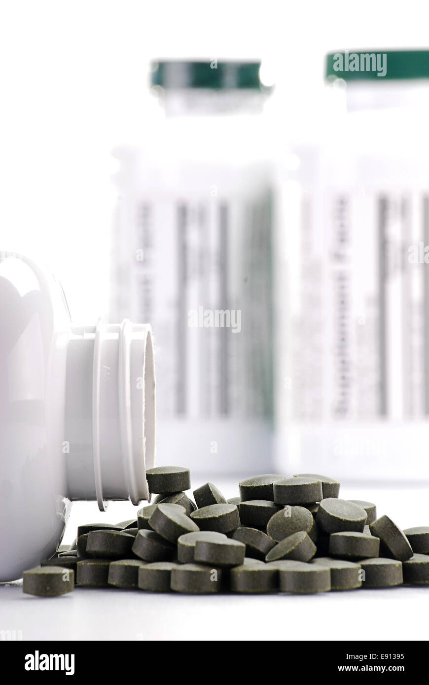 Dietary supplement tablets and containers Stock Photo - Alamy