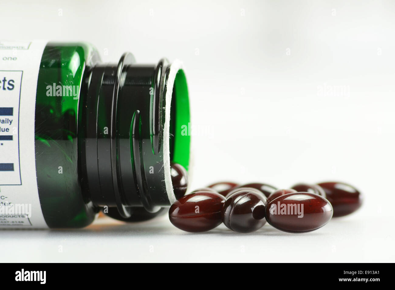 Dietary supplement capsules and container Stock Photo - Alamy