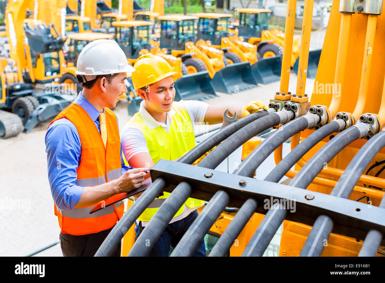 Asian motor mechanic discussing with engineer task list in construction ...