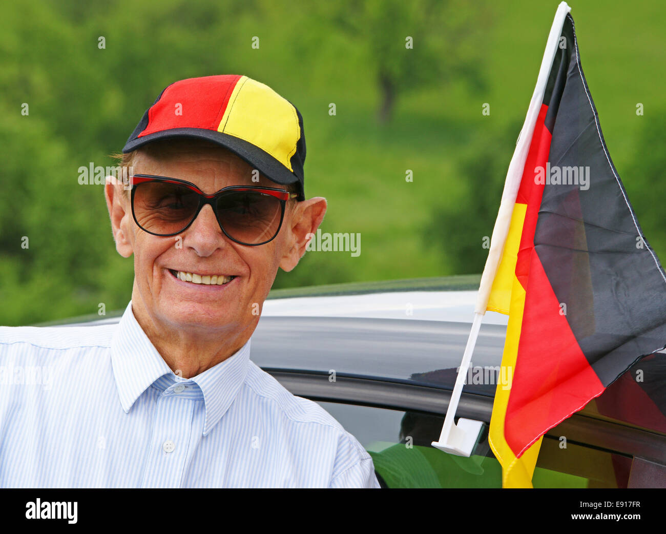 Senior Soccer Fan with Flag and Car Stock Photo - Alamy