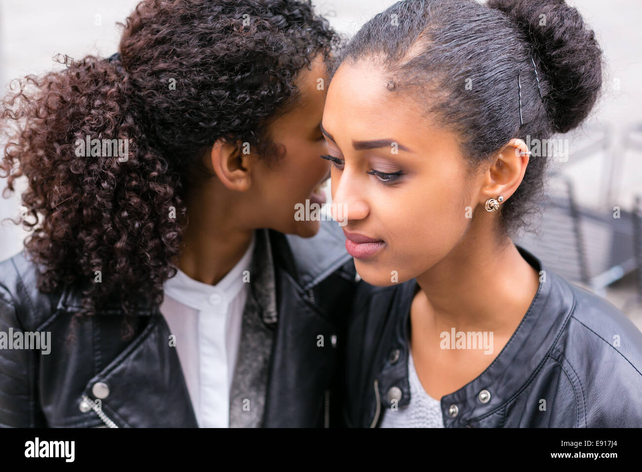 Two north African teen friends sitting together talking Stock Photo - Alamy