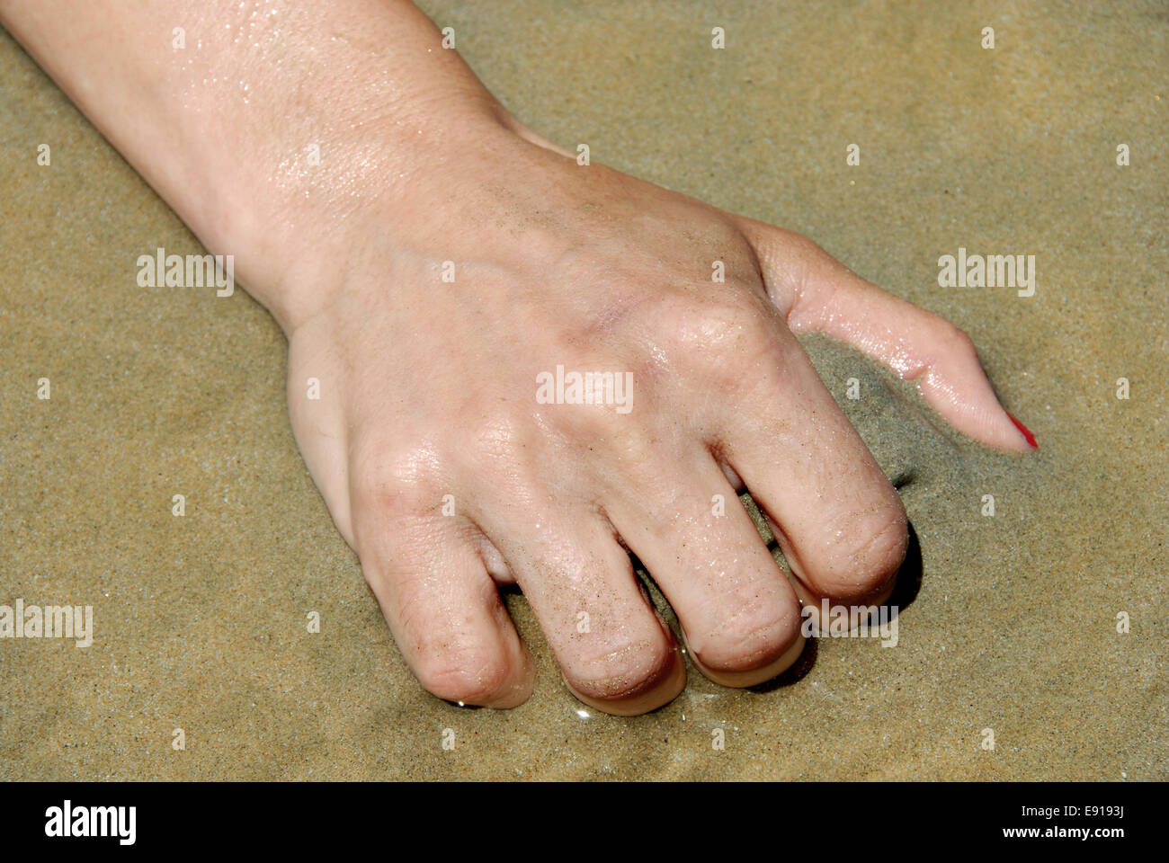 Hand grabbing sand Stock Photo - Alamy