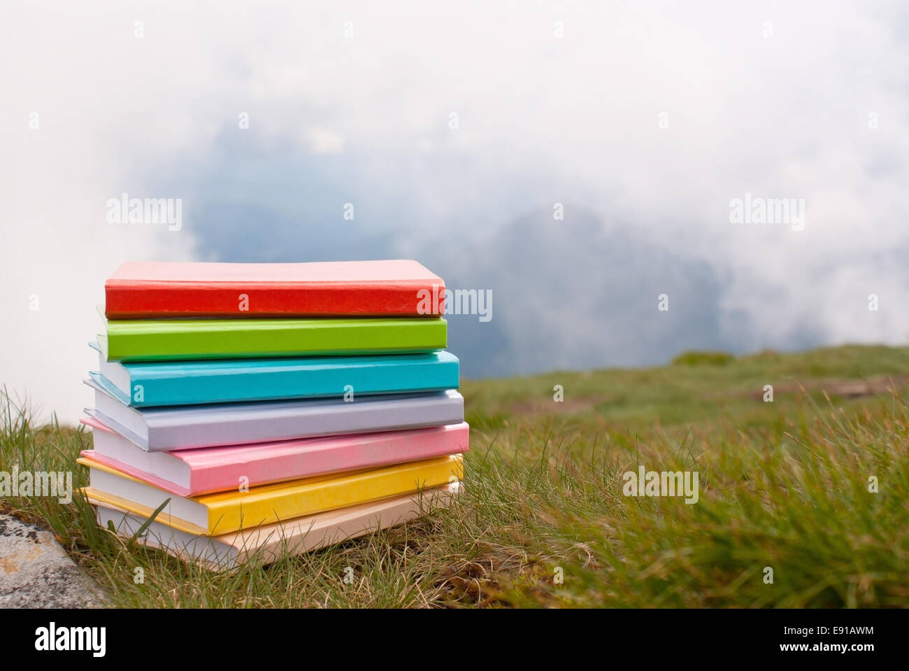 Stack of the books laying at the grass Stock Photo - Alamy