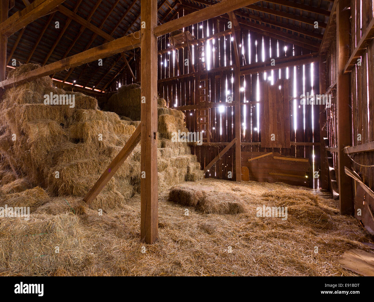 Interior of old barn with straw bales Stock Photo - Alamy