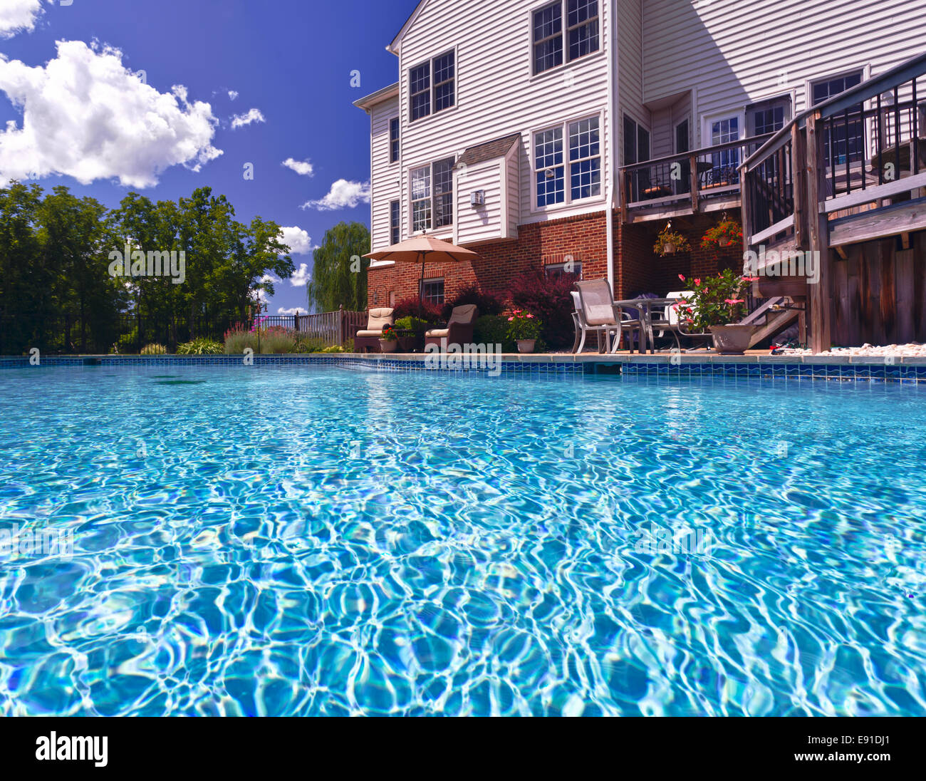 Backyard swimming pool and patio Stock Photo - Alamy