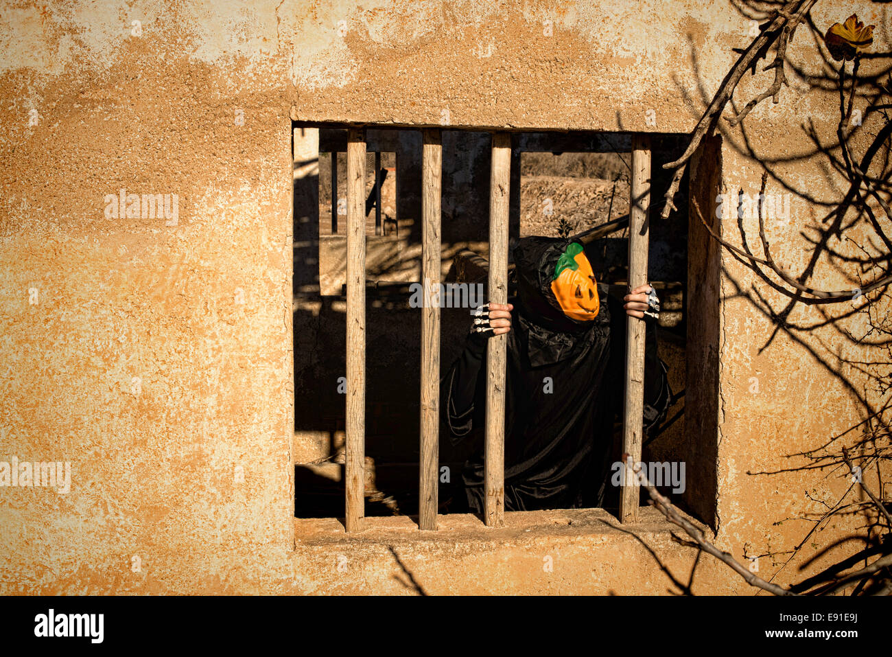 Halloween monster locked in behind window bars Stock Photo - Alamy