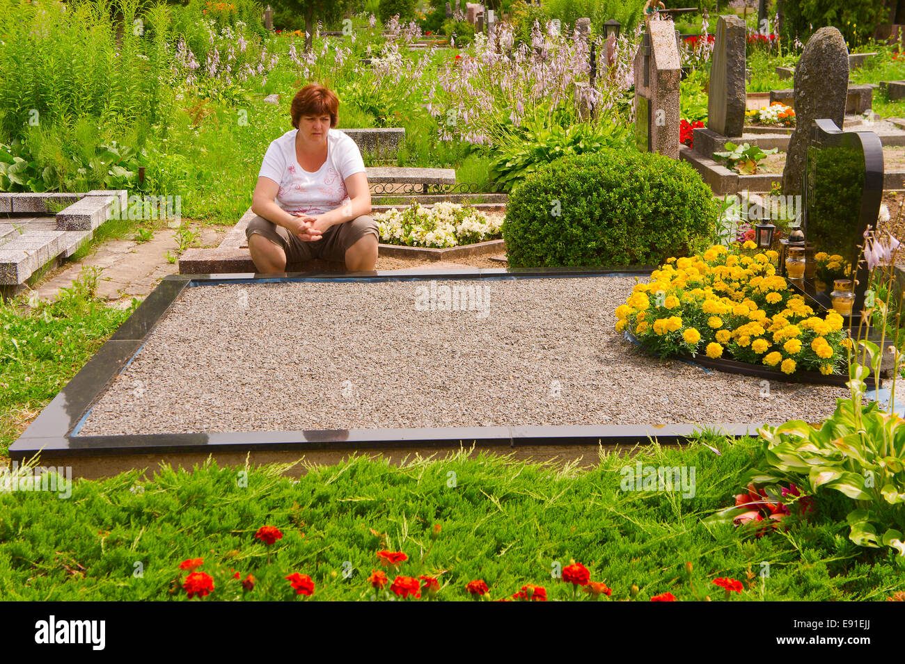 Woman in a cemetery hi-res stock photography and images - Alamy