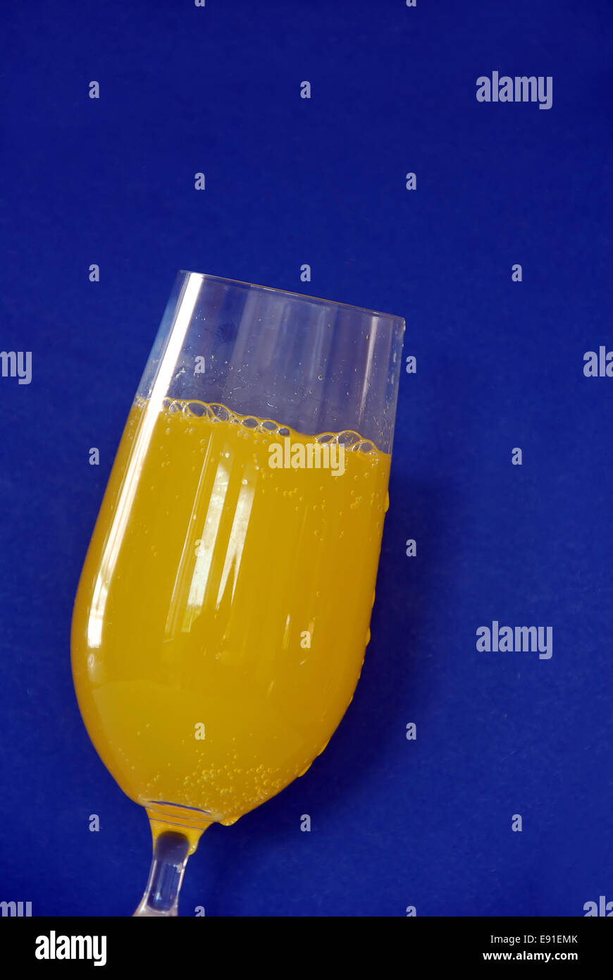 Yellow drink over blue Stock Photo - Alamy