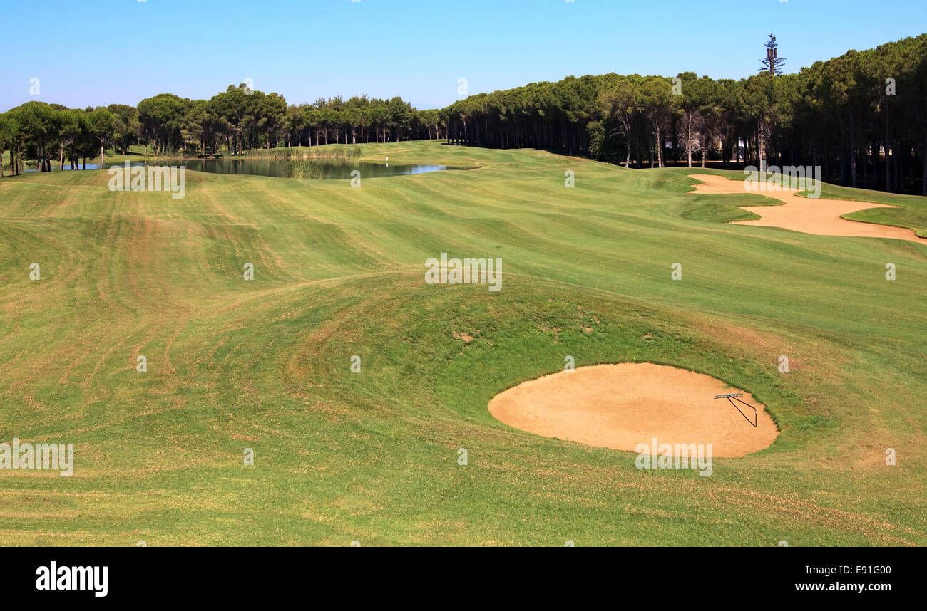 Golf course with bunker and water hazard Stock Photo - Alamy