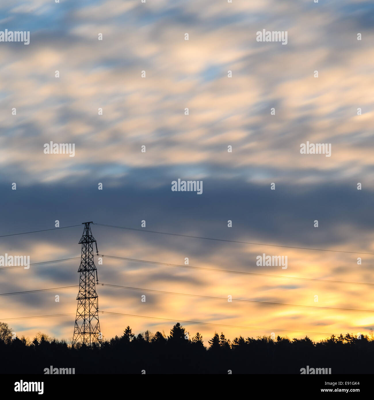 Electrical tower above the treeline at dusk Stock Photo - Alamy