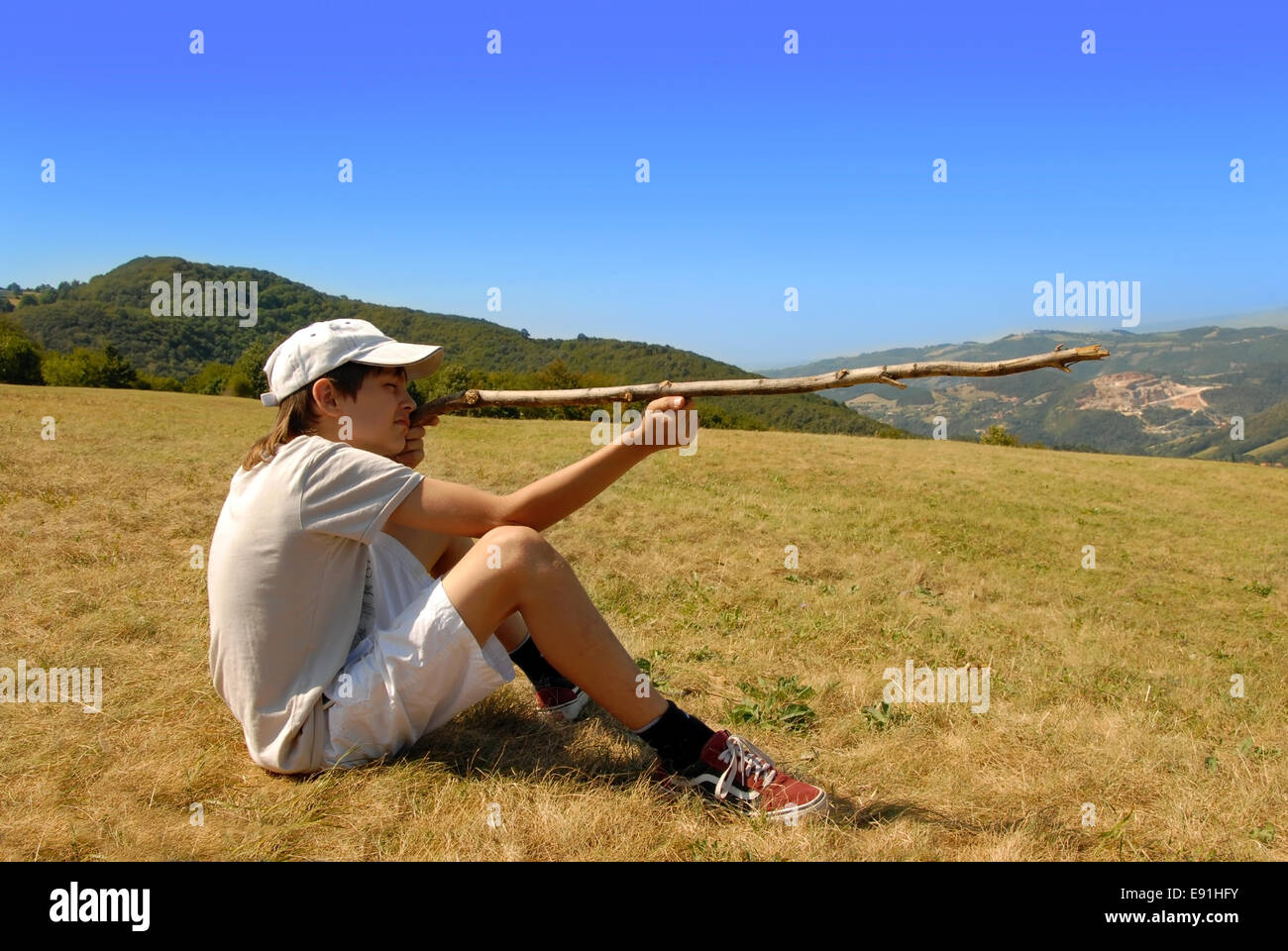 Boy with a stick, male games Stock Photo - Alamy