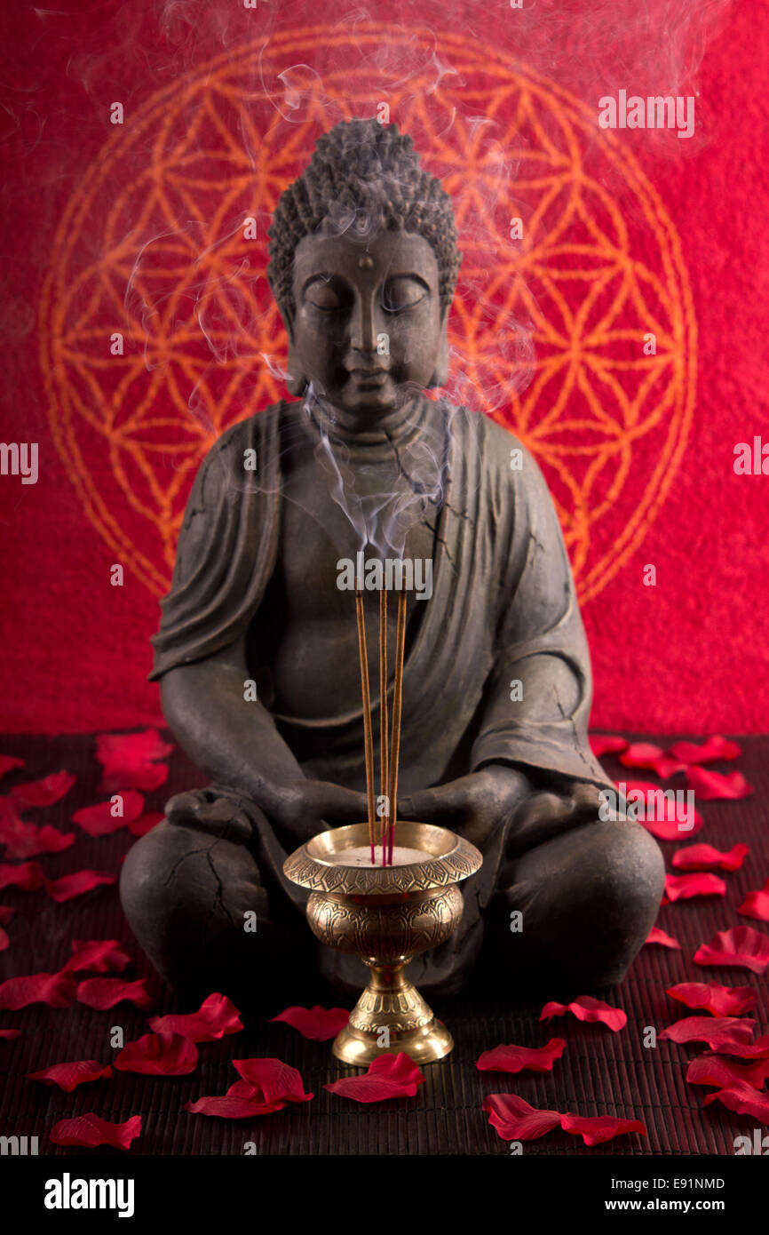 Buddha statue with incense sticks Stock Photo - Alamy