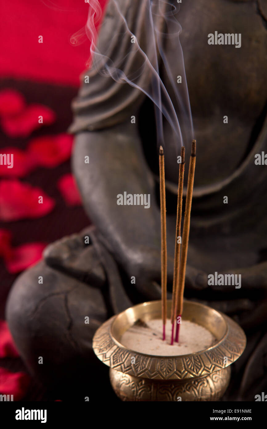 incense sticks with Buddha statue Stock Photo - Alamy