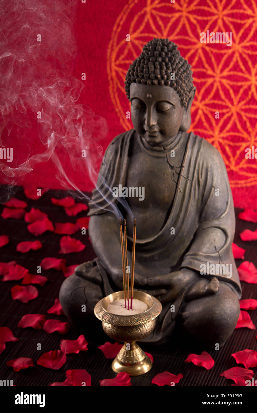 Buddha statue with incense sticks Stock Photo - Alamy