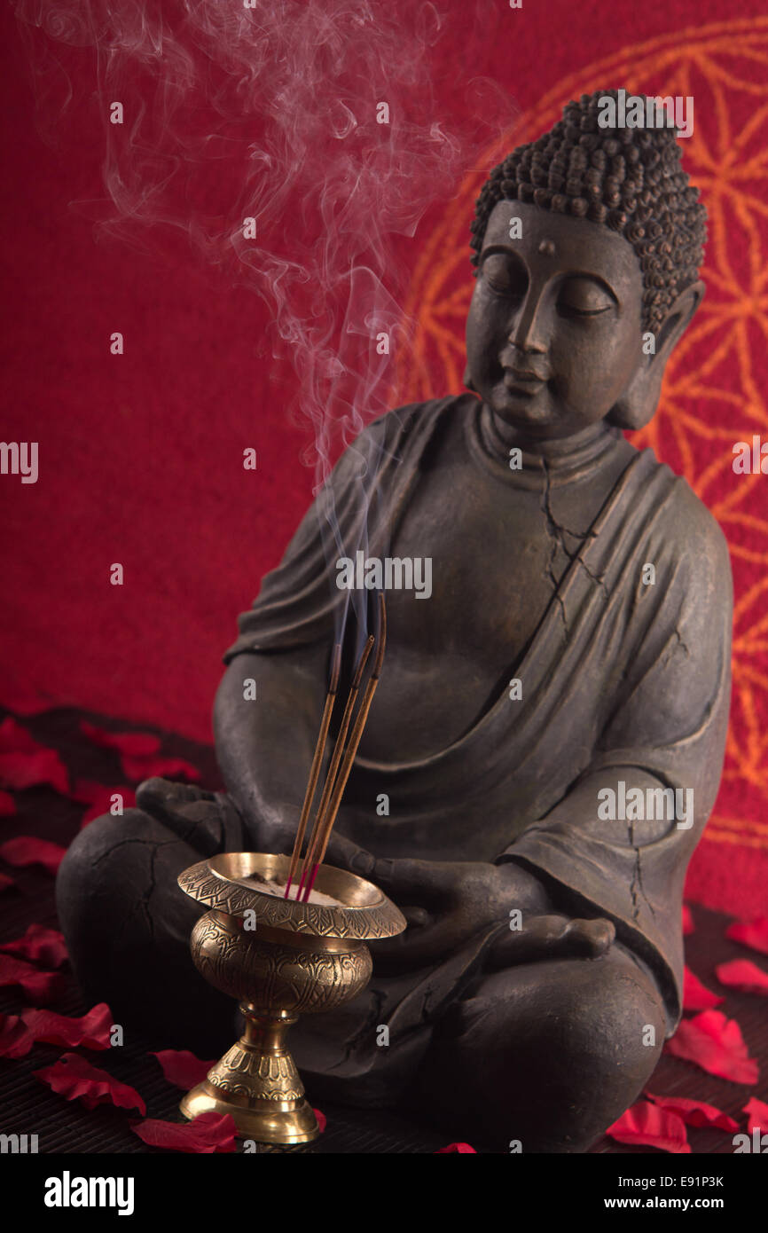 Buddha statue with incense sticks Stock Photo - Alamy