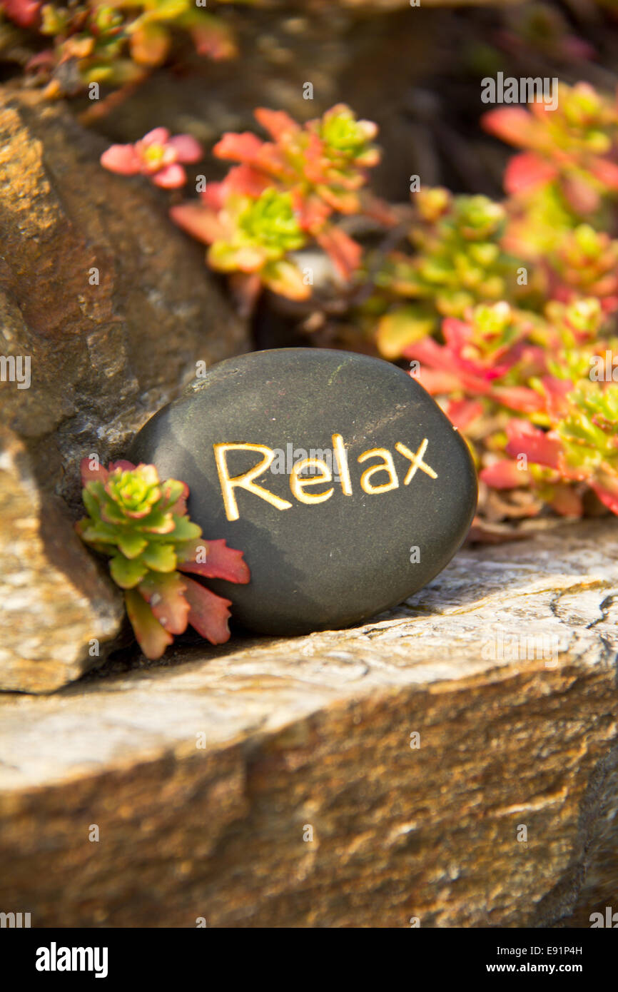 Massage stone with relax on a wall Stock Photo - Alamy