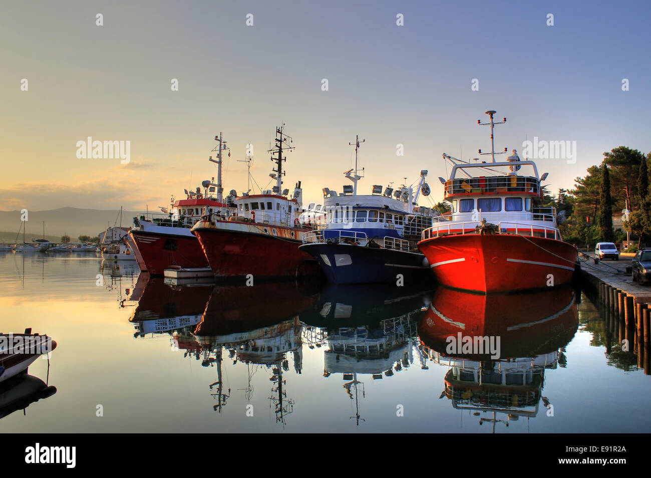 Fishing boats on early morning on calm sea Stock Photo - Alamy