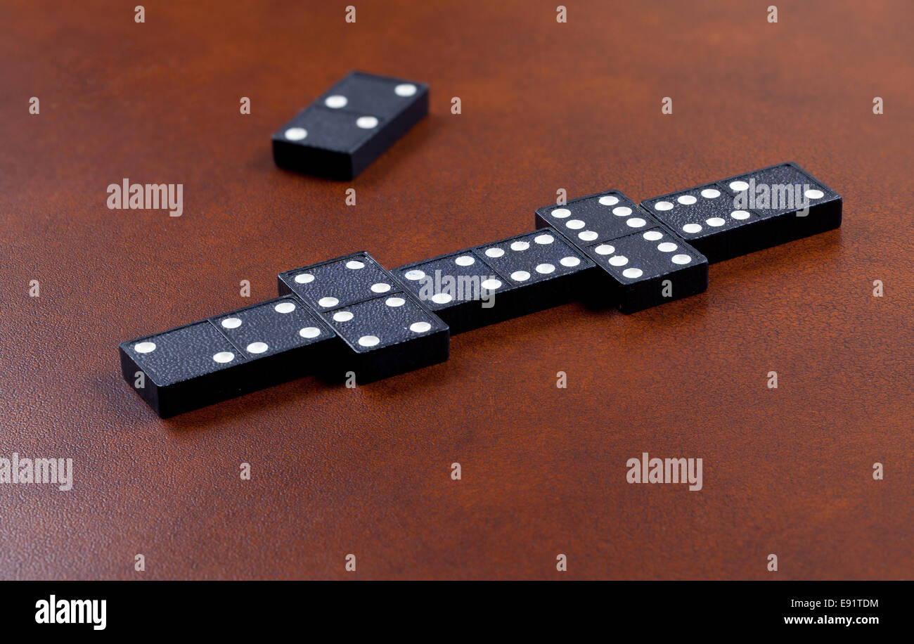 Game of dominoes on leather table Stock Photo - Alamy